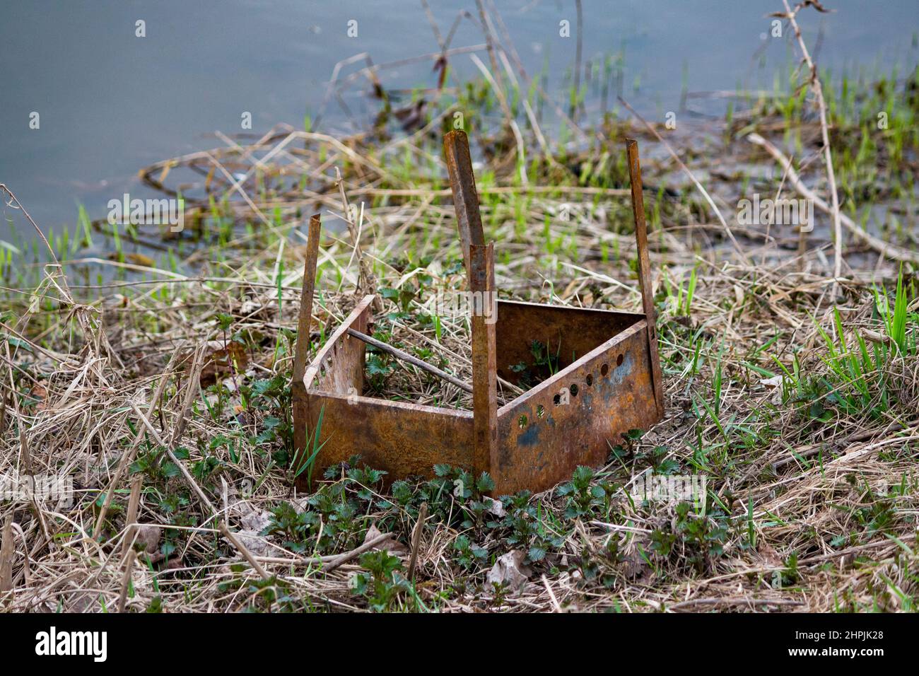 Used and discarded in nature broken disposable brazier Stock Photo - Alamy
