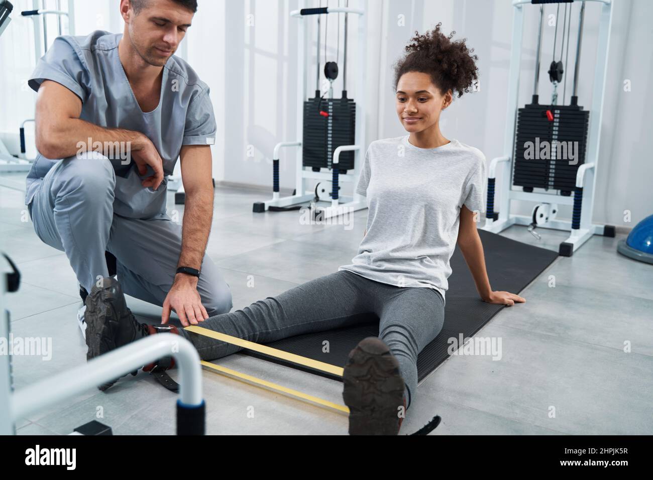 American female doing leg exercise in the gym Stock Photo - Alamy