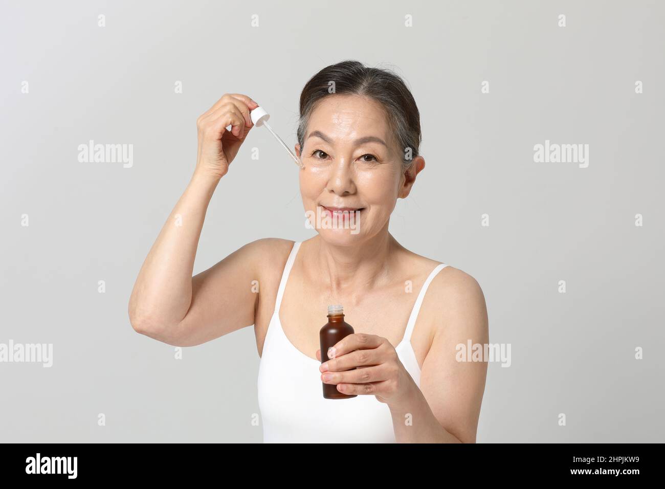 Asian Korean senior woman, basic skin care beauty concept in studio ...