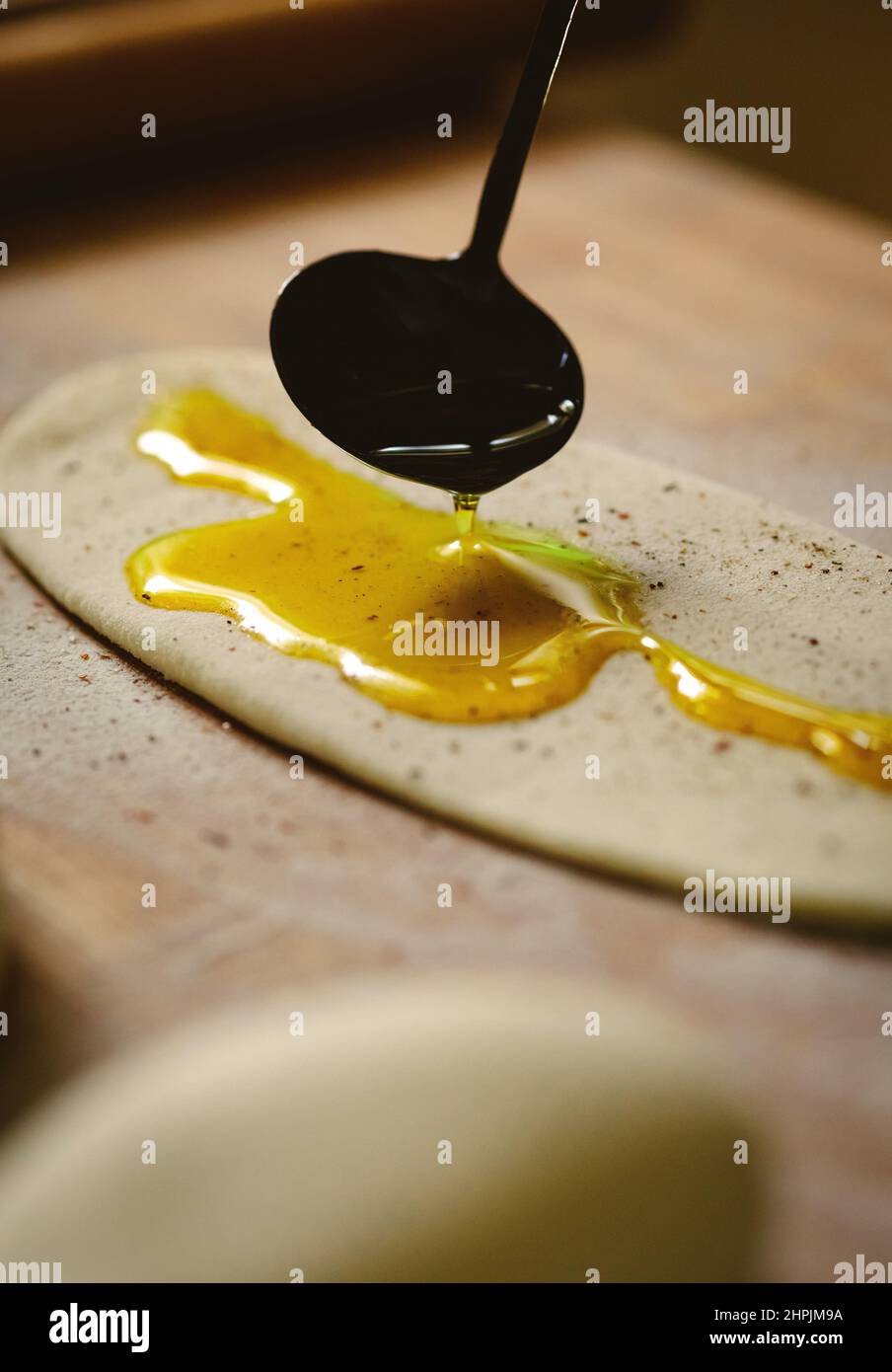 Chef hand pouring oil hi-res stock photography and images - Alamy