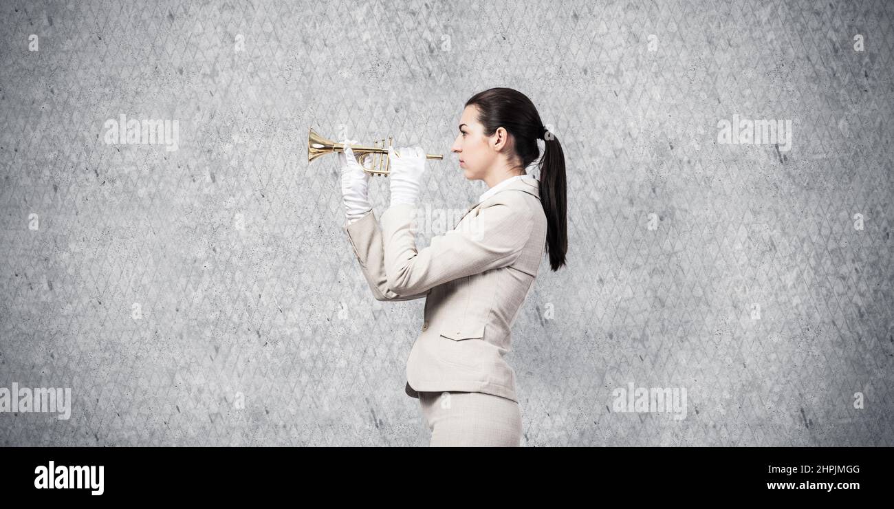 Beautiful woman playing trumpet brass Stock Photo - Alamy