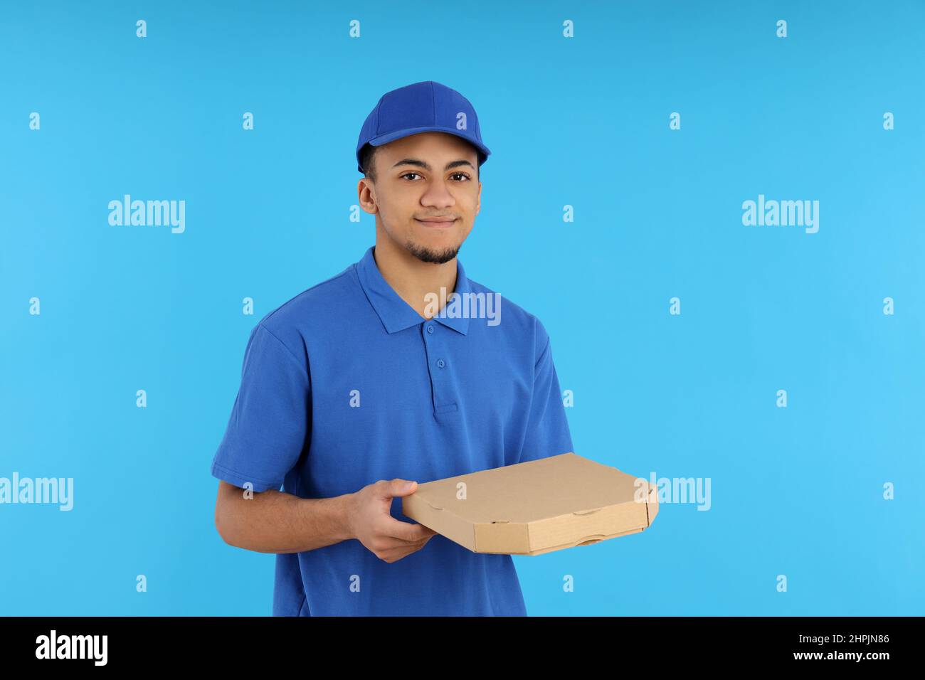 Young adult black delivery man hi-res stock photography and images - Alamy