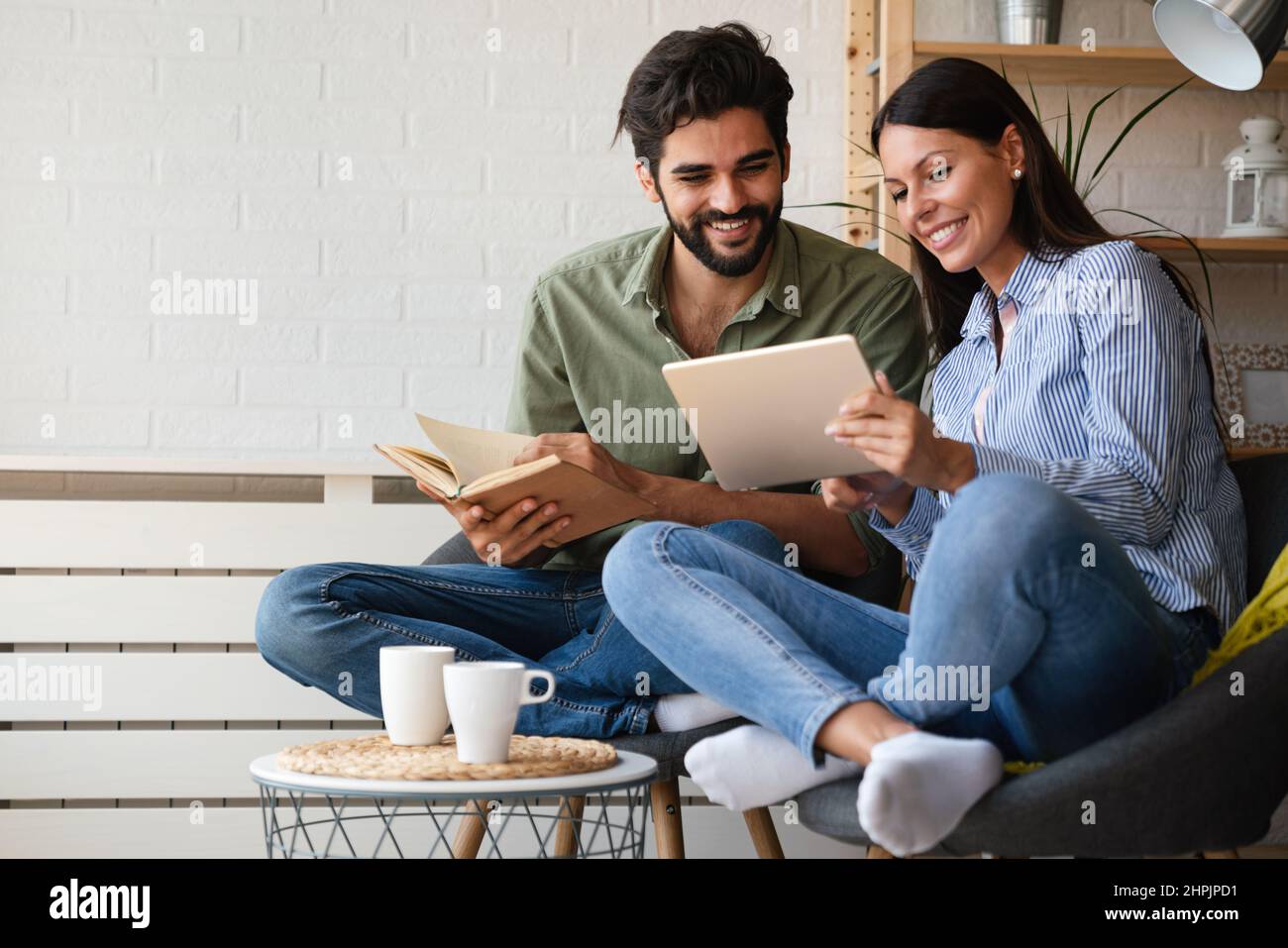 Spending nice time at home. Couple bonding to each other and smiling ...