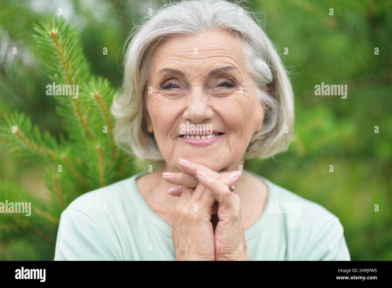 Portrait of happy smiling senior woman posing outdoors Stock Photo - Alamy