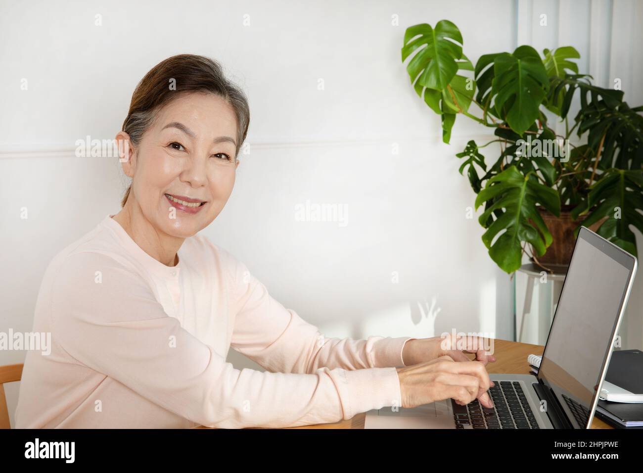 Asian Korean senior woman studying with a laptop Stock Photo - Alamy