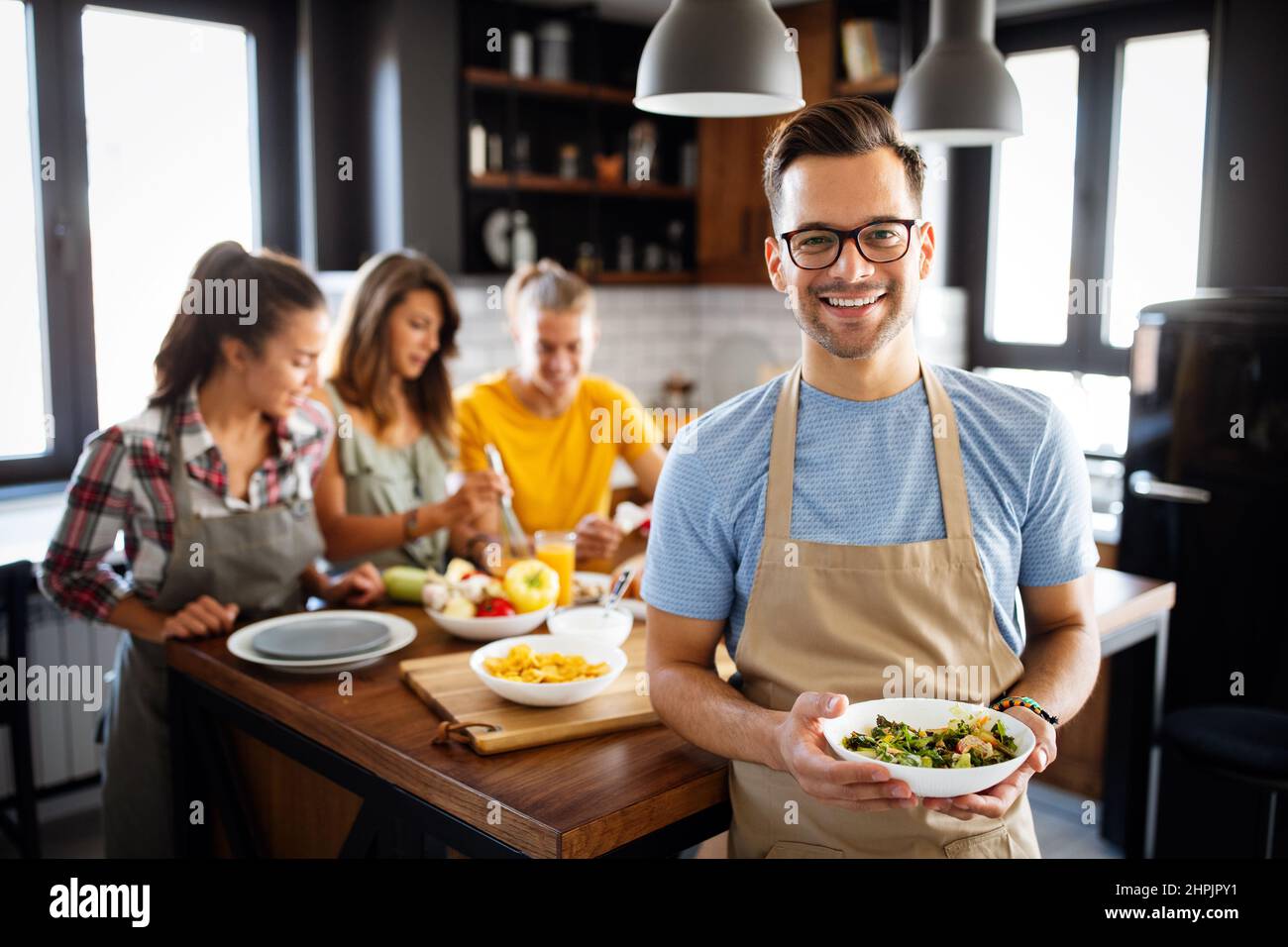 Young women and young men in kitchen hi-res stock photography and ...
