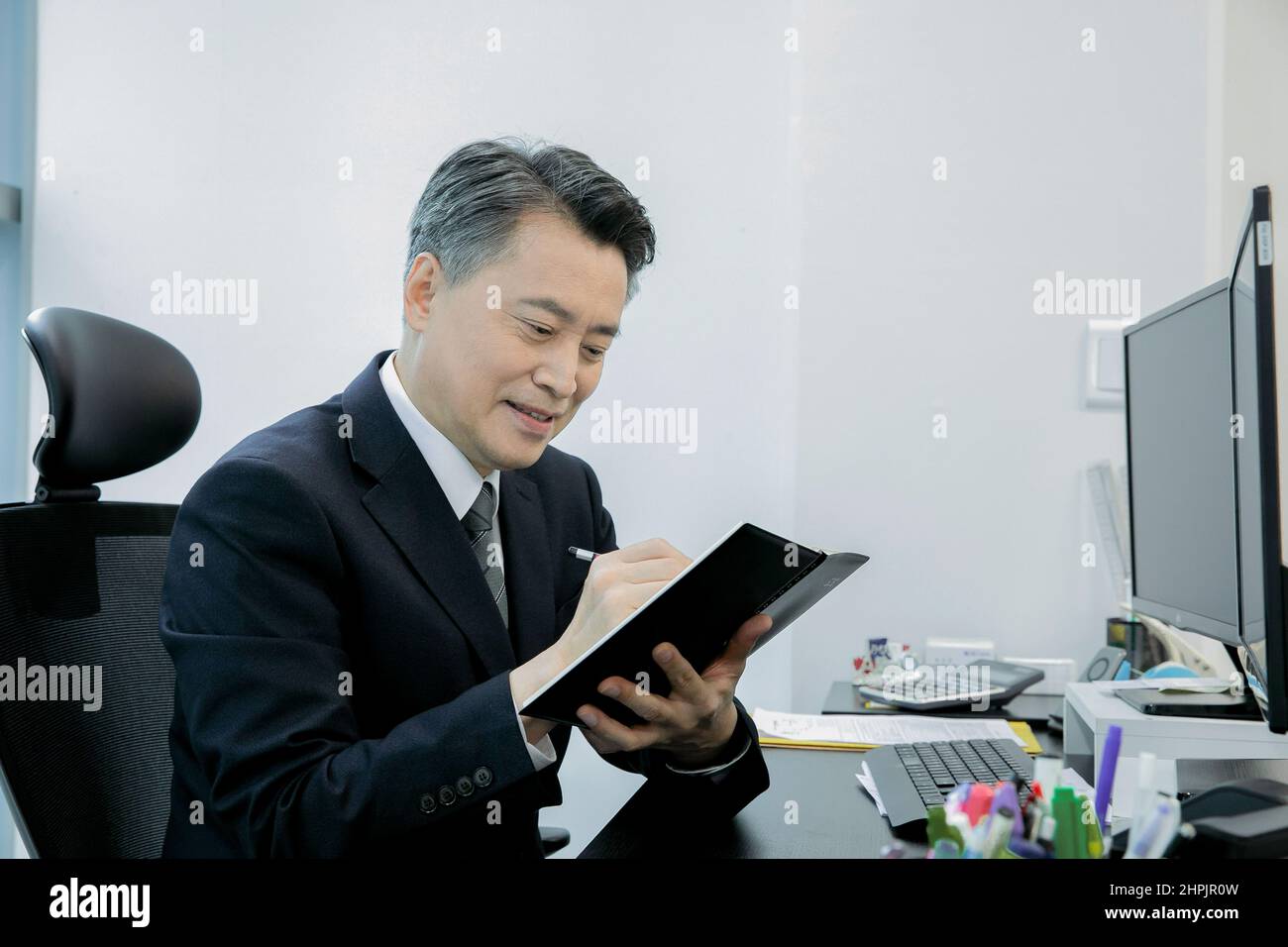 business concept asian korean man taking notes Stock Photo - Alamy