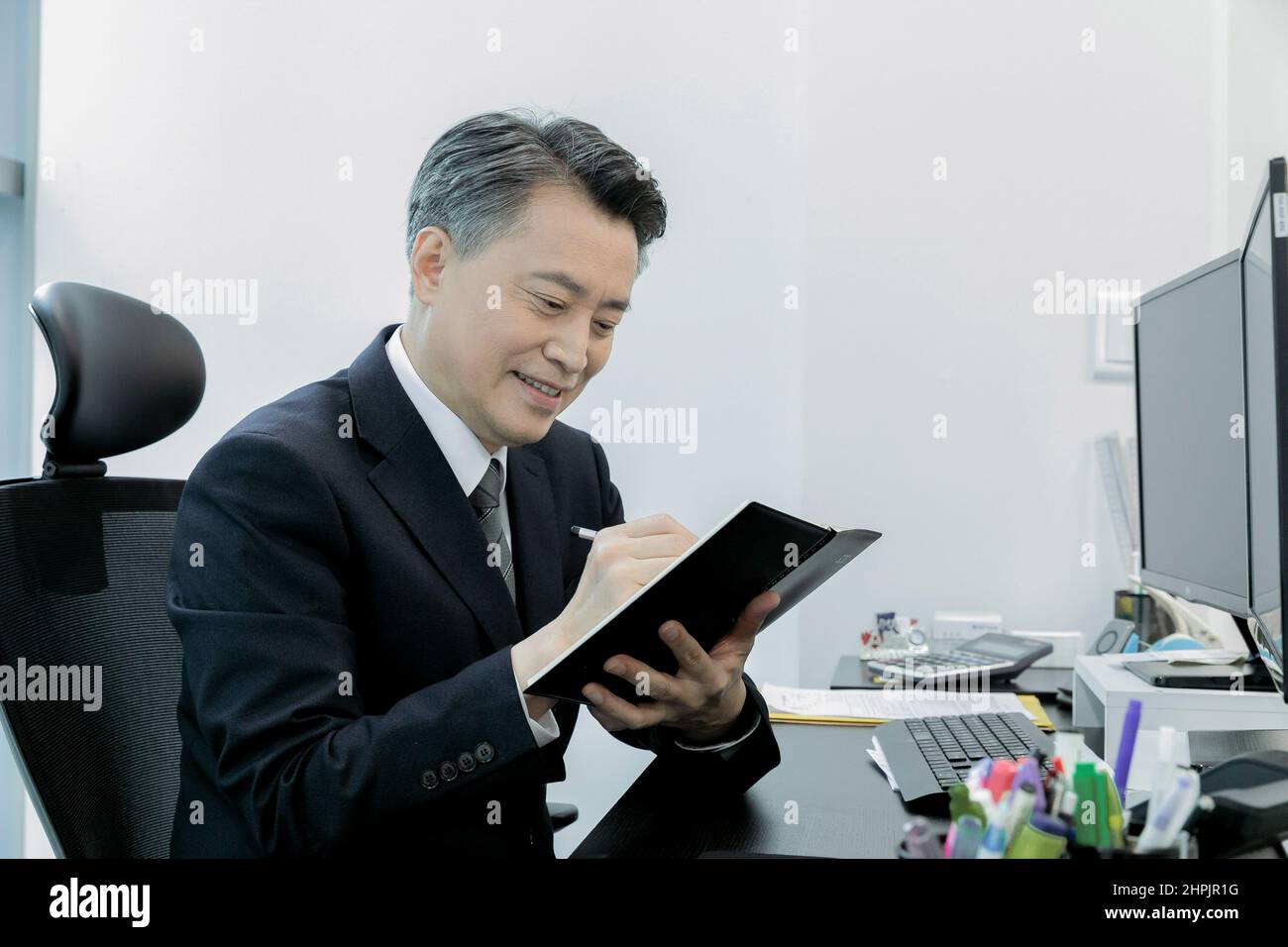 business concept asian korean man taking notes Stock Photo - Alamy