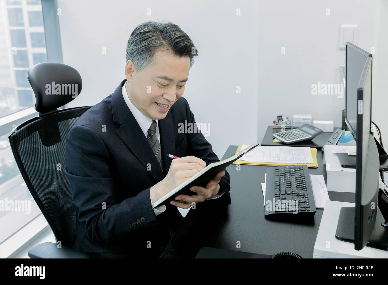 business concept asian korean man taking notes Stock Photo - Alamy