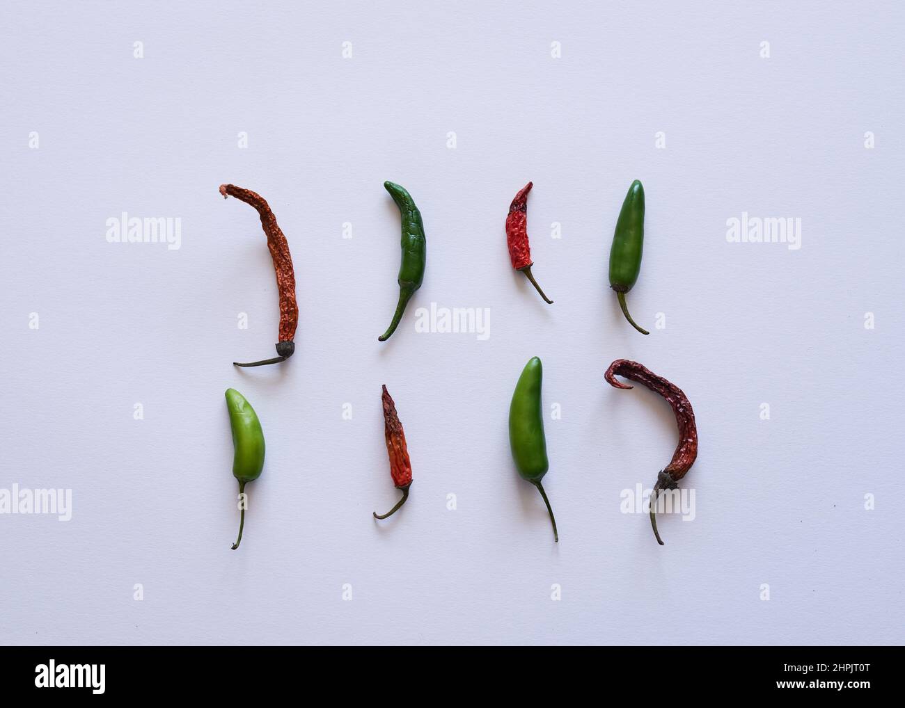 Capsicum chili in red and green on a white background. Top View flat ...
