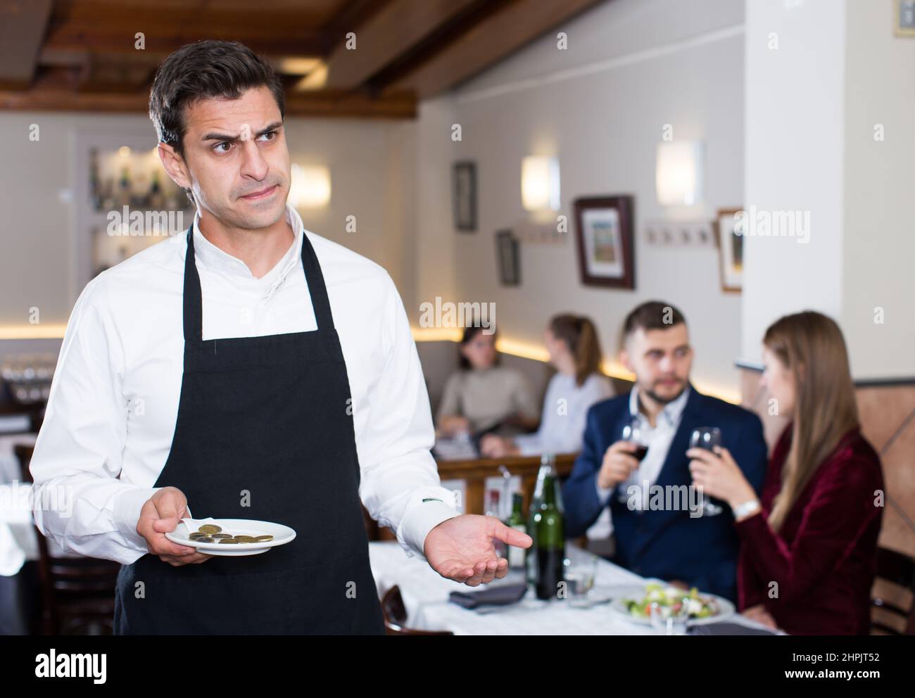 Waiter dissatisfied with small tip Stock Photo - Alamy