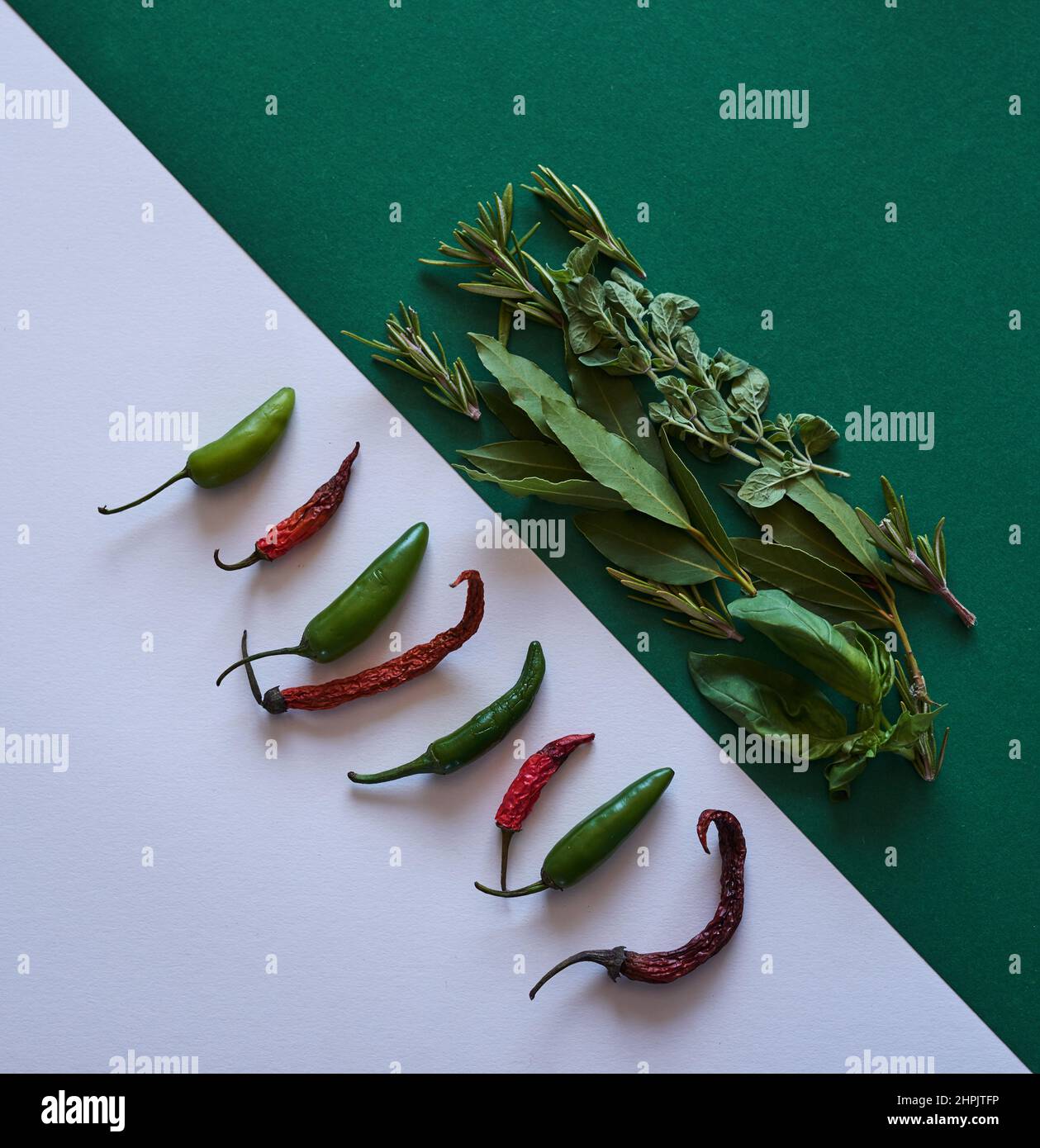 Chili and herbs arranged in a pattern on contrasting backgrounds. Top ...