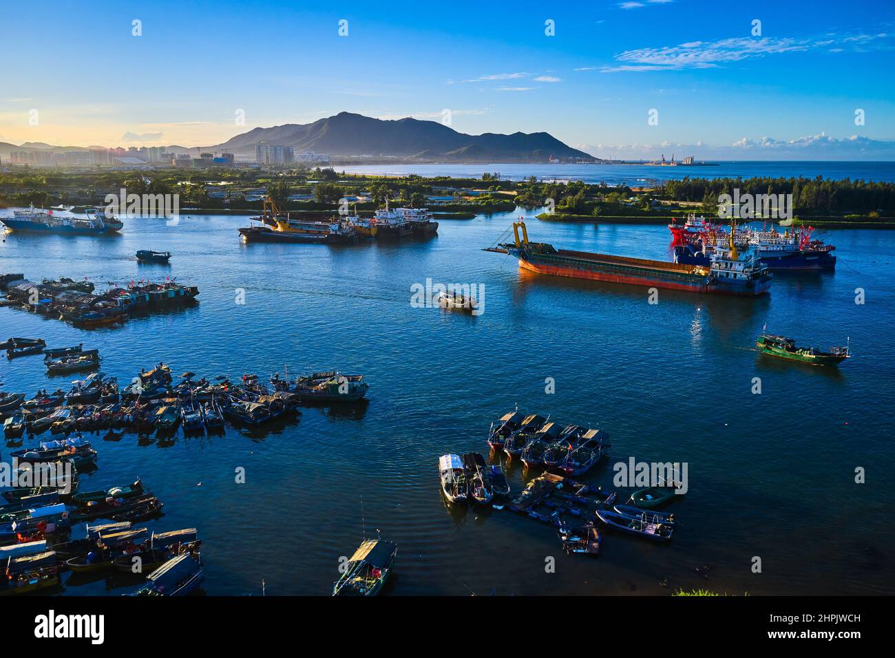 The cliff state sanya bay fishing port dawn Stock Photo - Alamy
