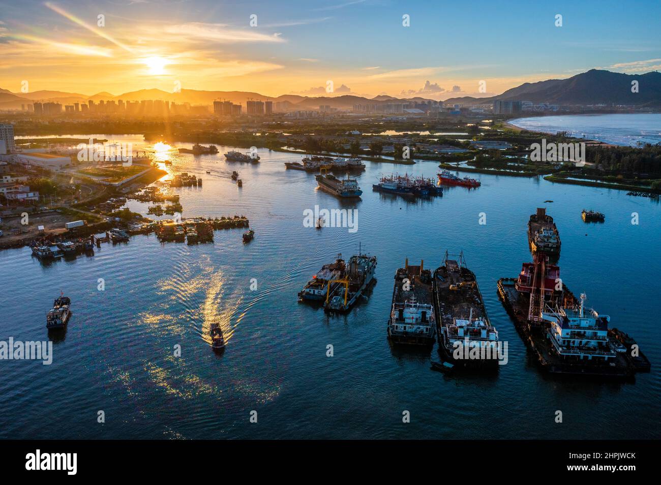 The cliff state sanya bay fishing port dawn Stock Photo - Alamy