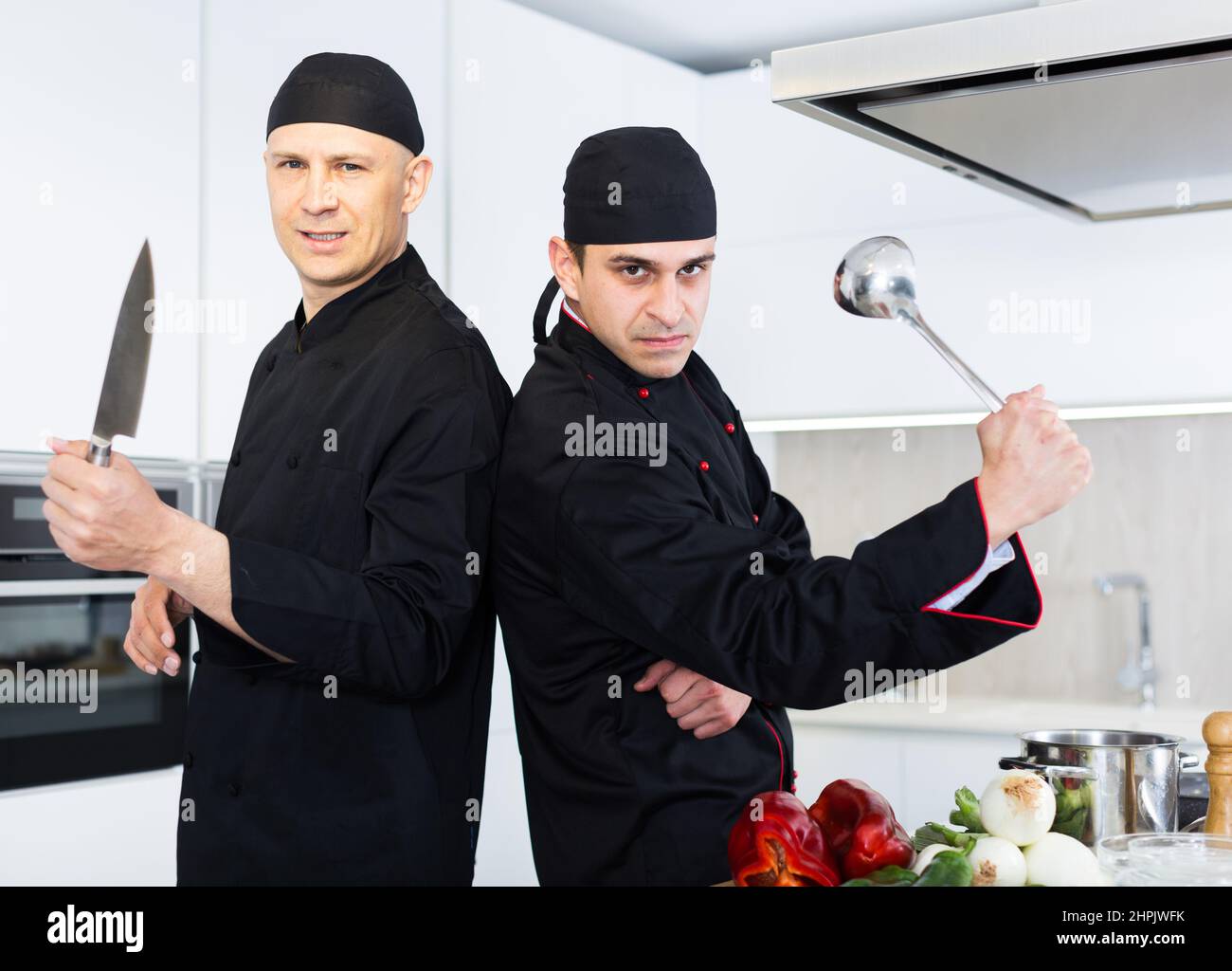 Two male kitchener in uniform are standing in the kitchen Stock Photo ...
