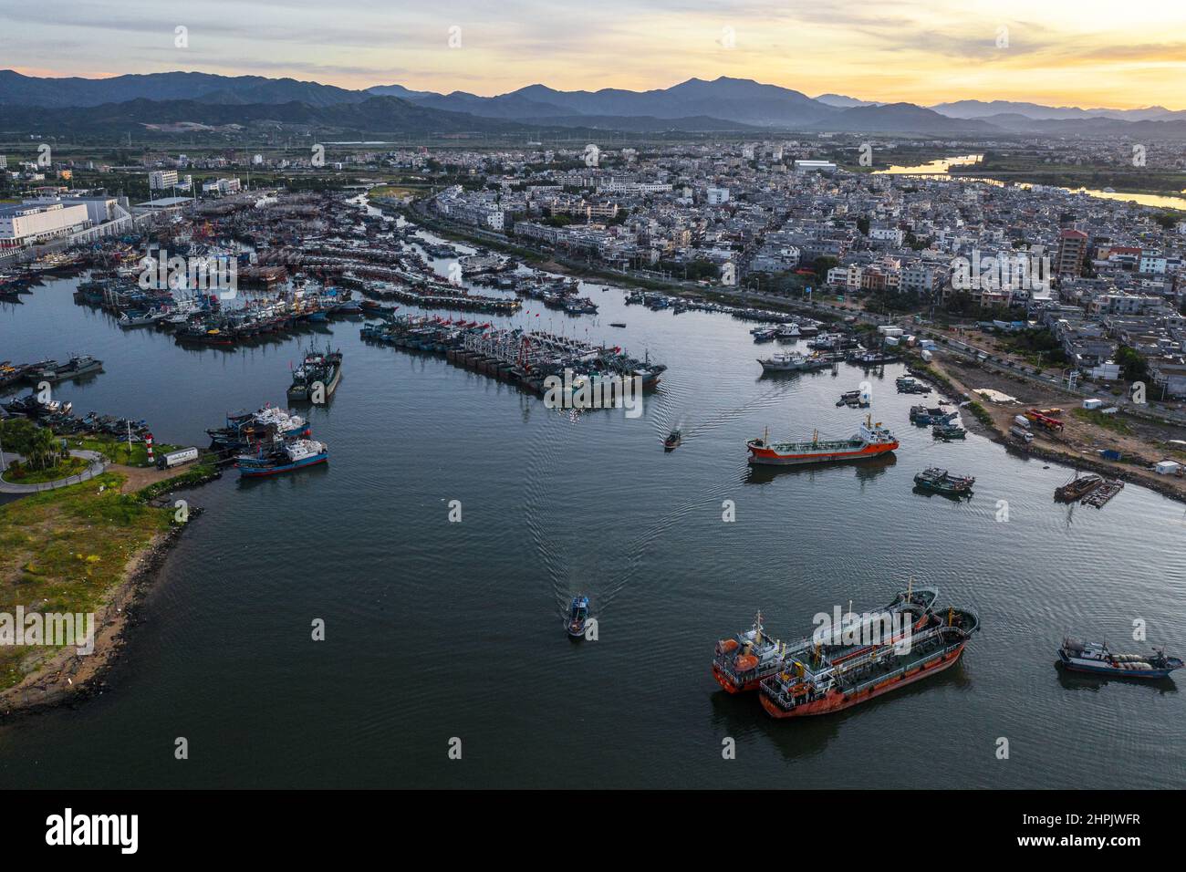 The sanya cliff state fishing port dawn Stock Photo - Alamy