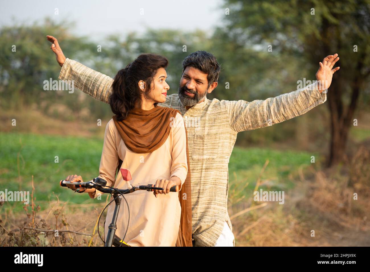 Happy rural indian father and daughter bicycle at village, young girl ...