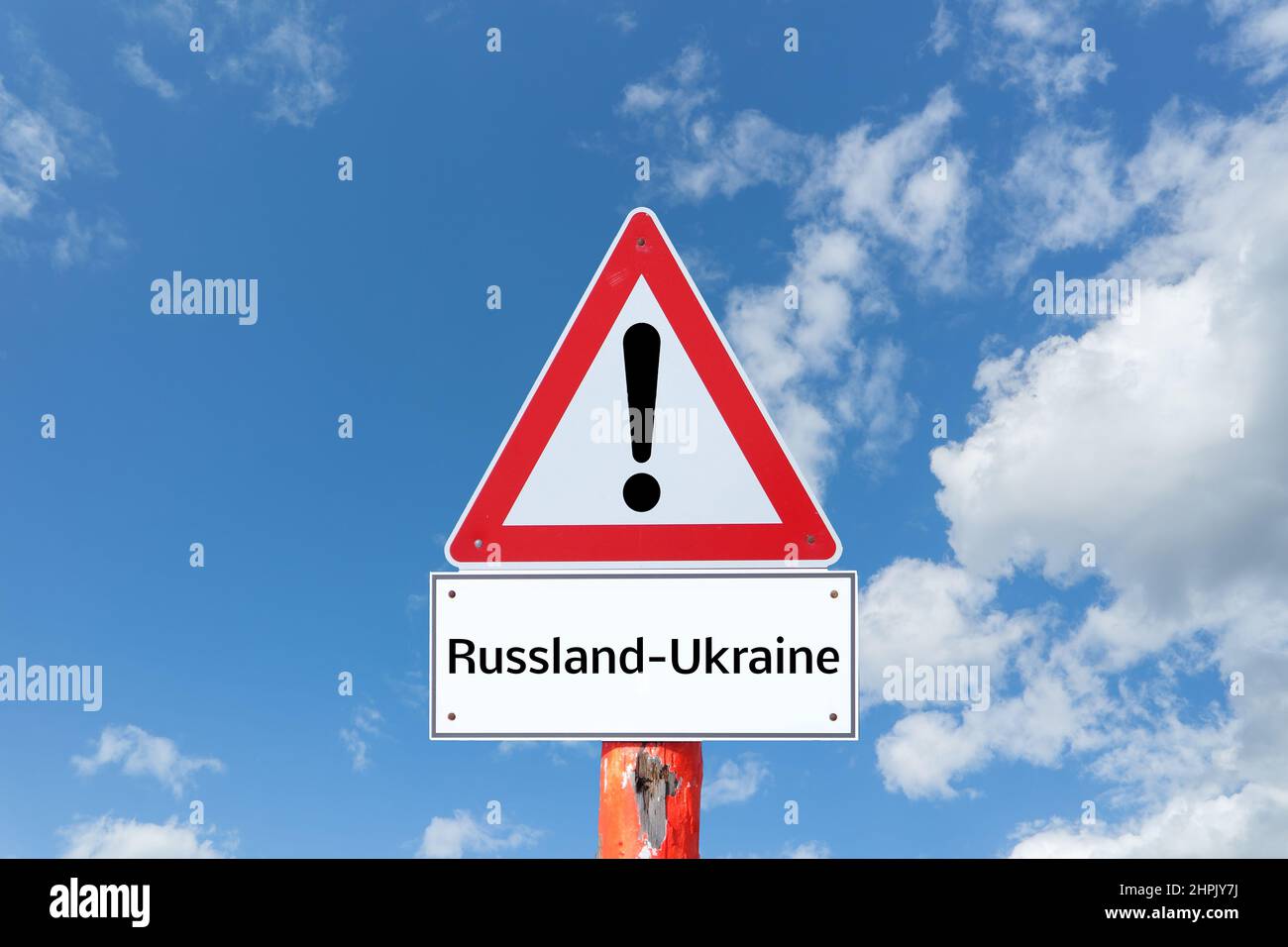 Warning sign Russia Ukraine on blue background in german Stock Photo ...