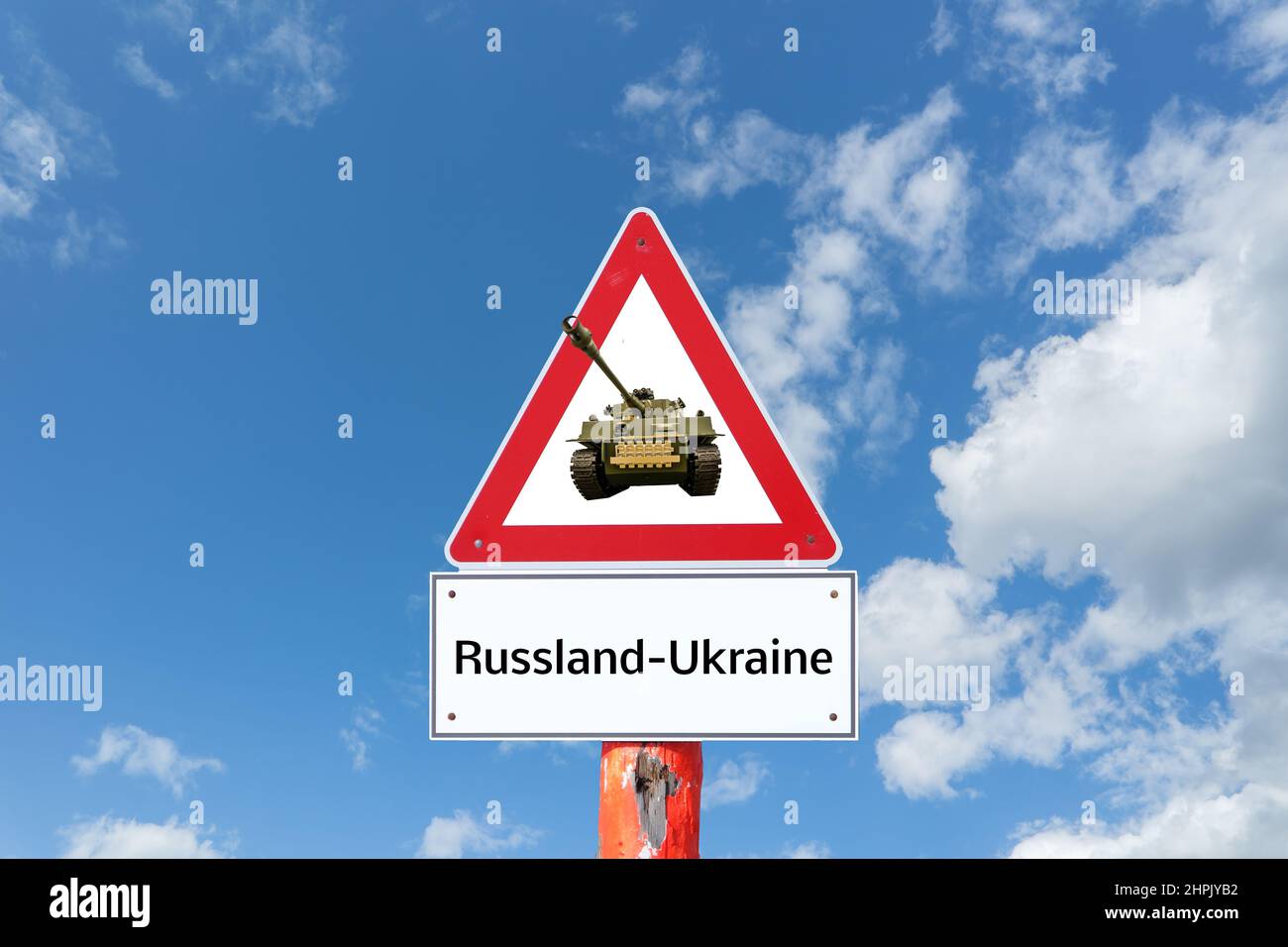 Russia Ukraine warning sign with tank and blue sky in german Stock ...