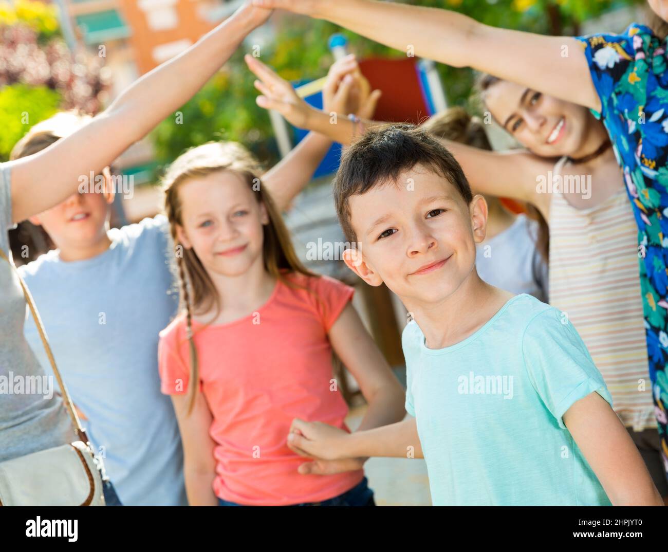 Two kids with children playing at playground Stock Photo - Alamy