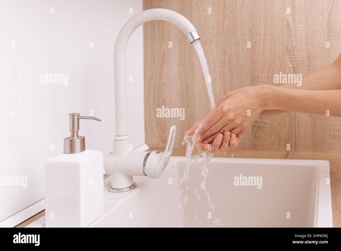 Washing hands under the flowing water tap. Hygiene concept hand detail ...