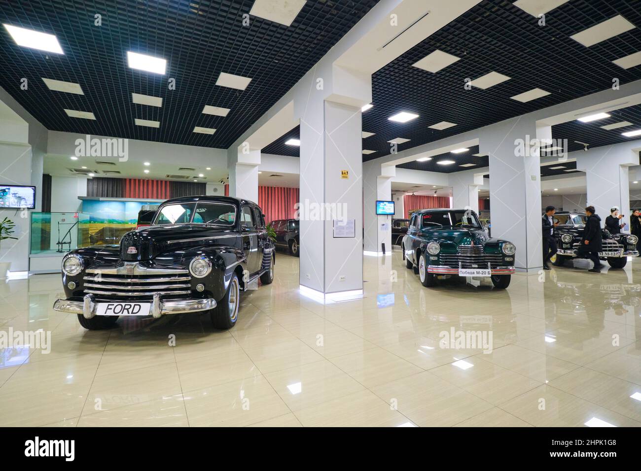 A group of black Soviet, Russian, USSR, CCCP luxury cars with a Ford V8 ...