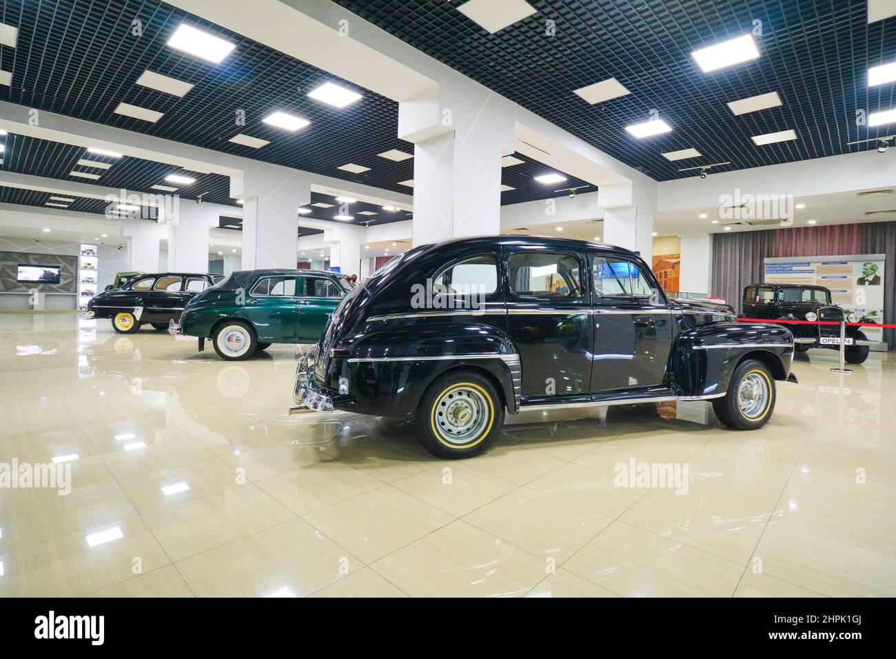 A group of black Soviet, Russian, USSR, CCCP luxury cars with a Ford V8 ...