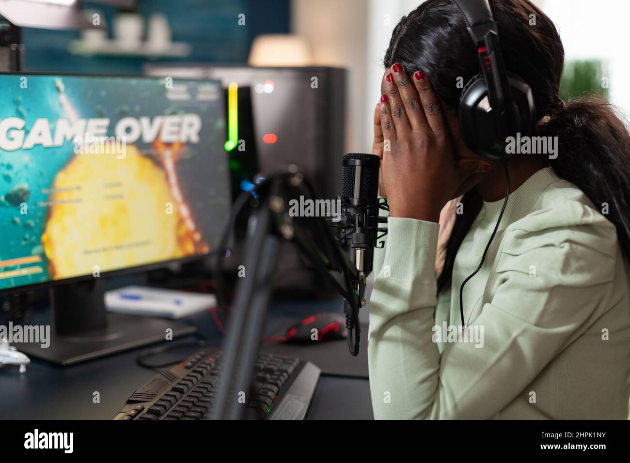Upset pro woman gamer playing online video games losing space shooter ...