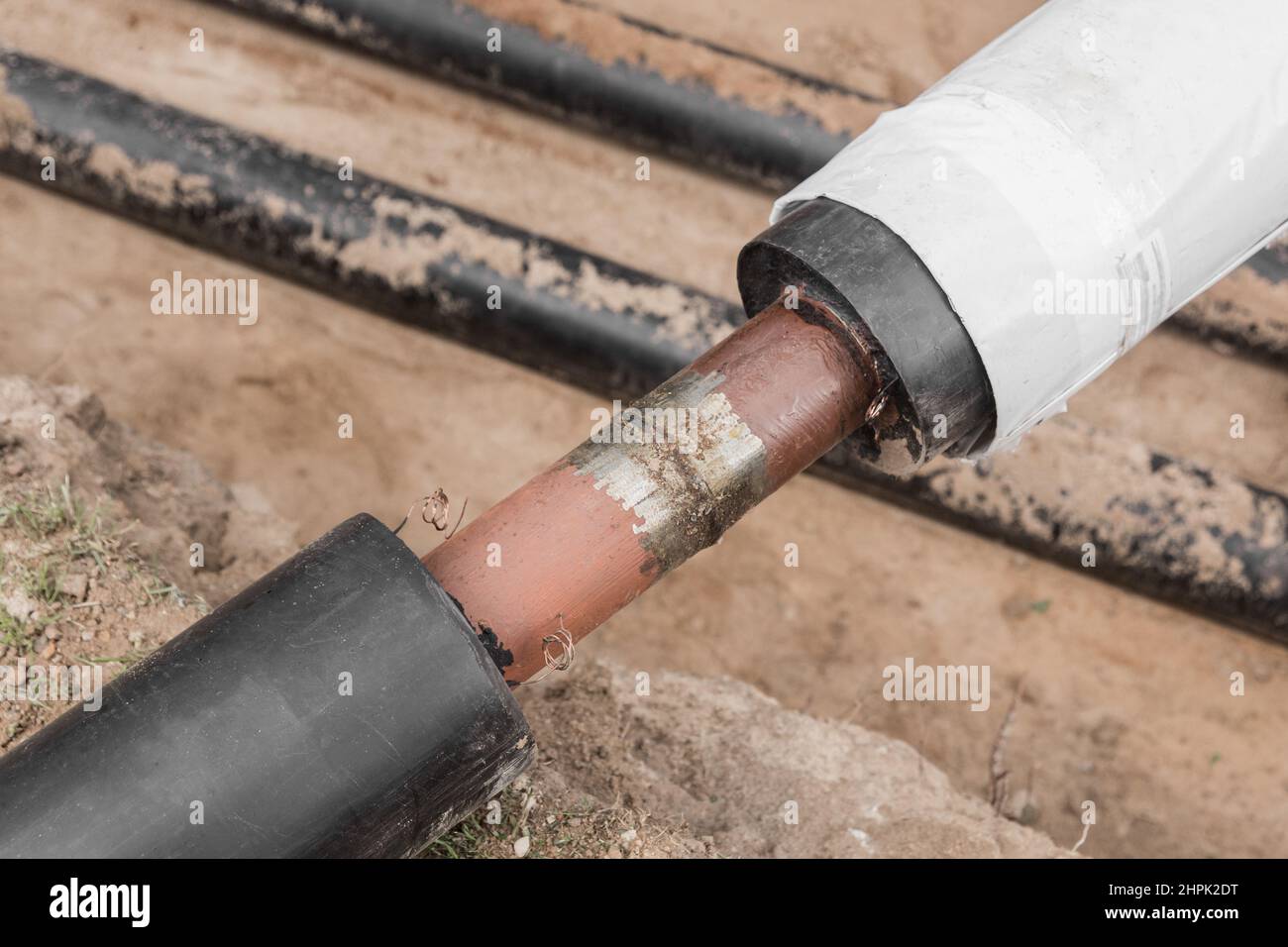 Repair of the water line of the heating main pipe in the ground trench ...