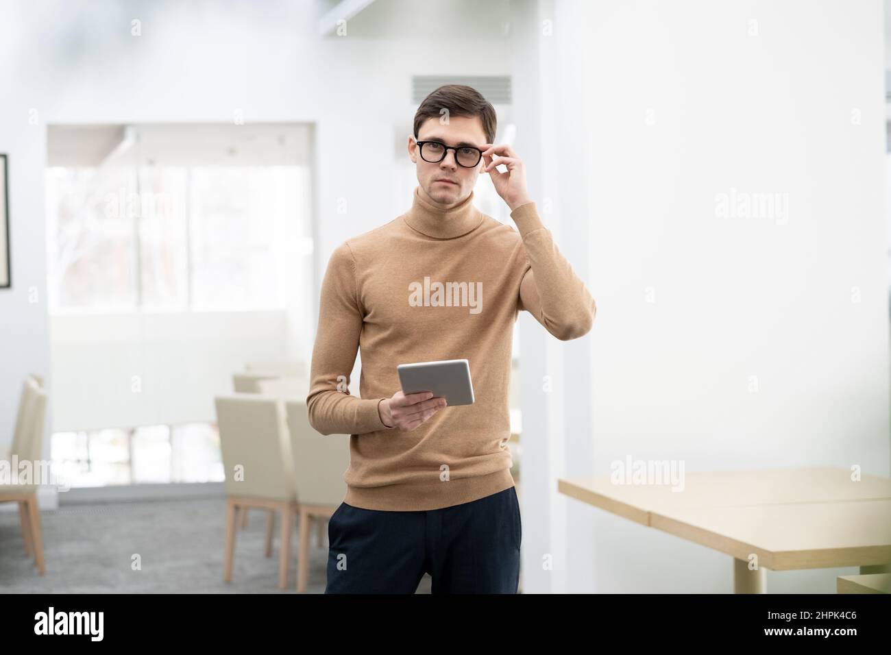 Young contemporary ceo of large high tech corporation with digital ...