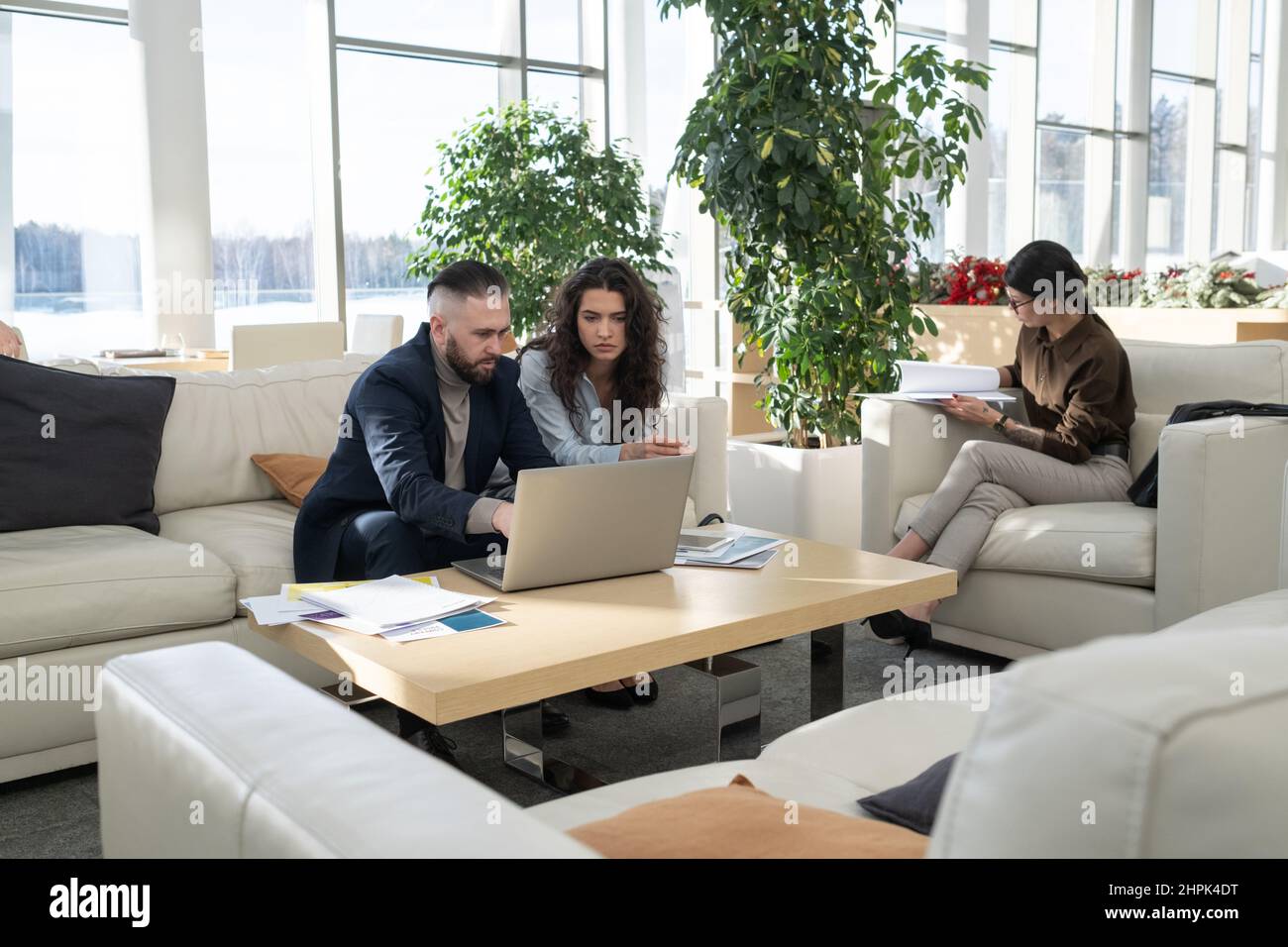 Two confident statistics managers discussing new strategies by ...