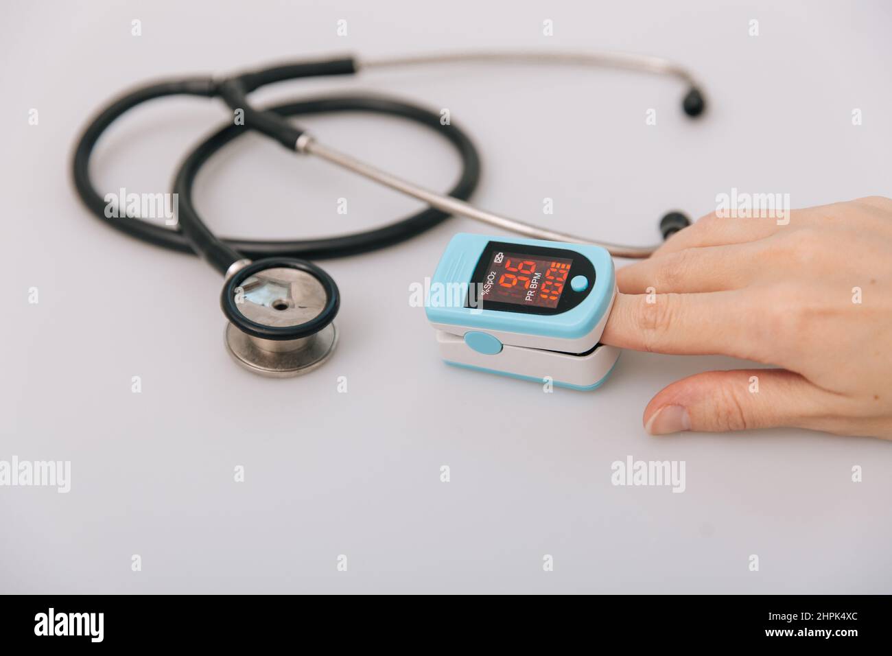 Stethoscope, pulse oximeter and thermometer gun on white background ...