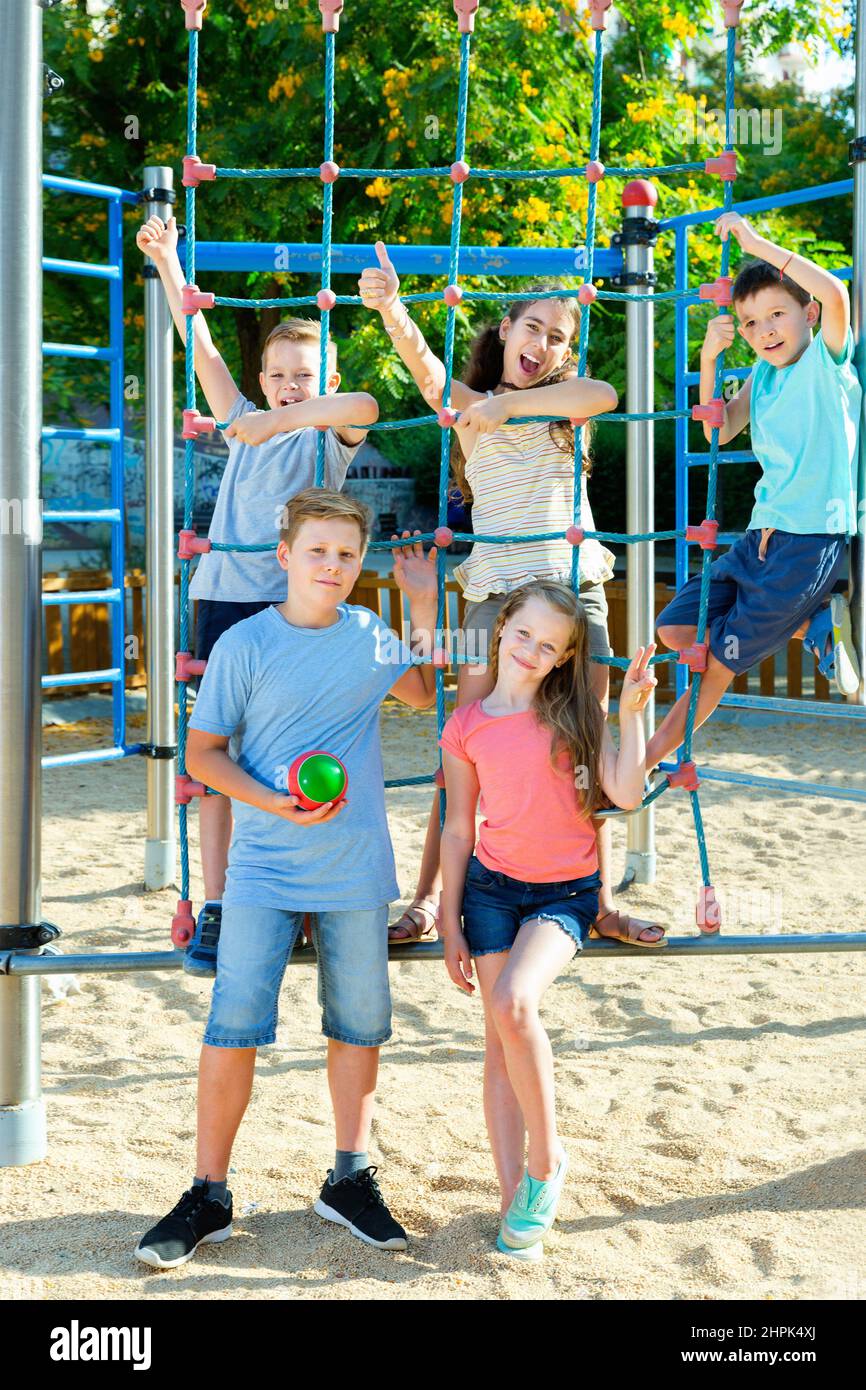 Five kids posing at the playground together Stock Photo - Alamy