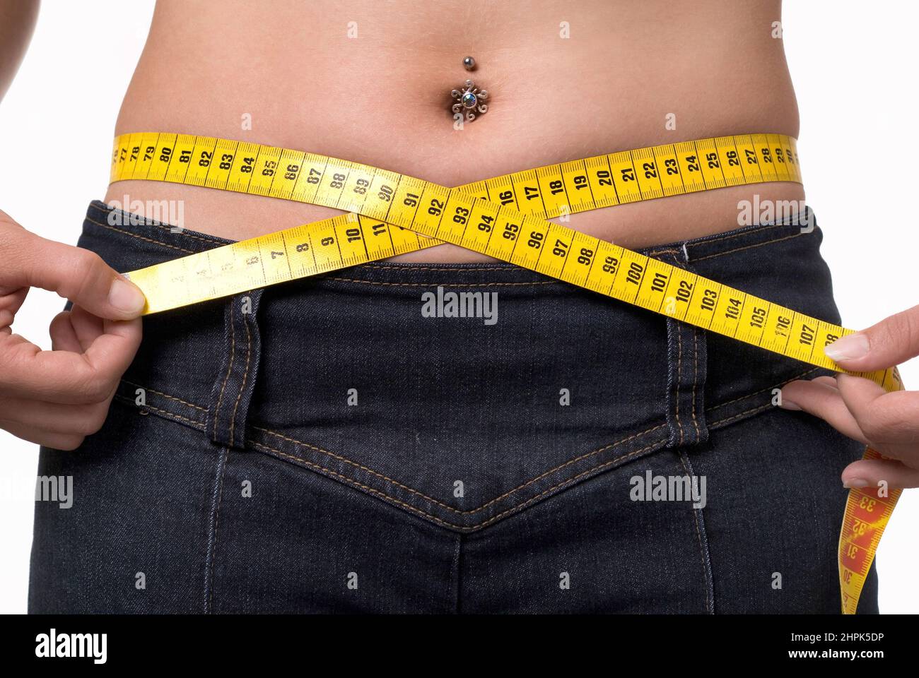 Young woman with a measuring tape as a symbol for body cult, diet and ...