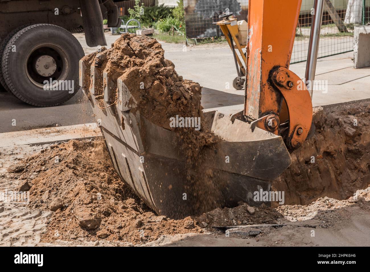 Excavation works. Tractor bucket digging with a heavy shovel on the ...