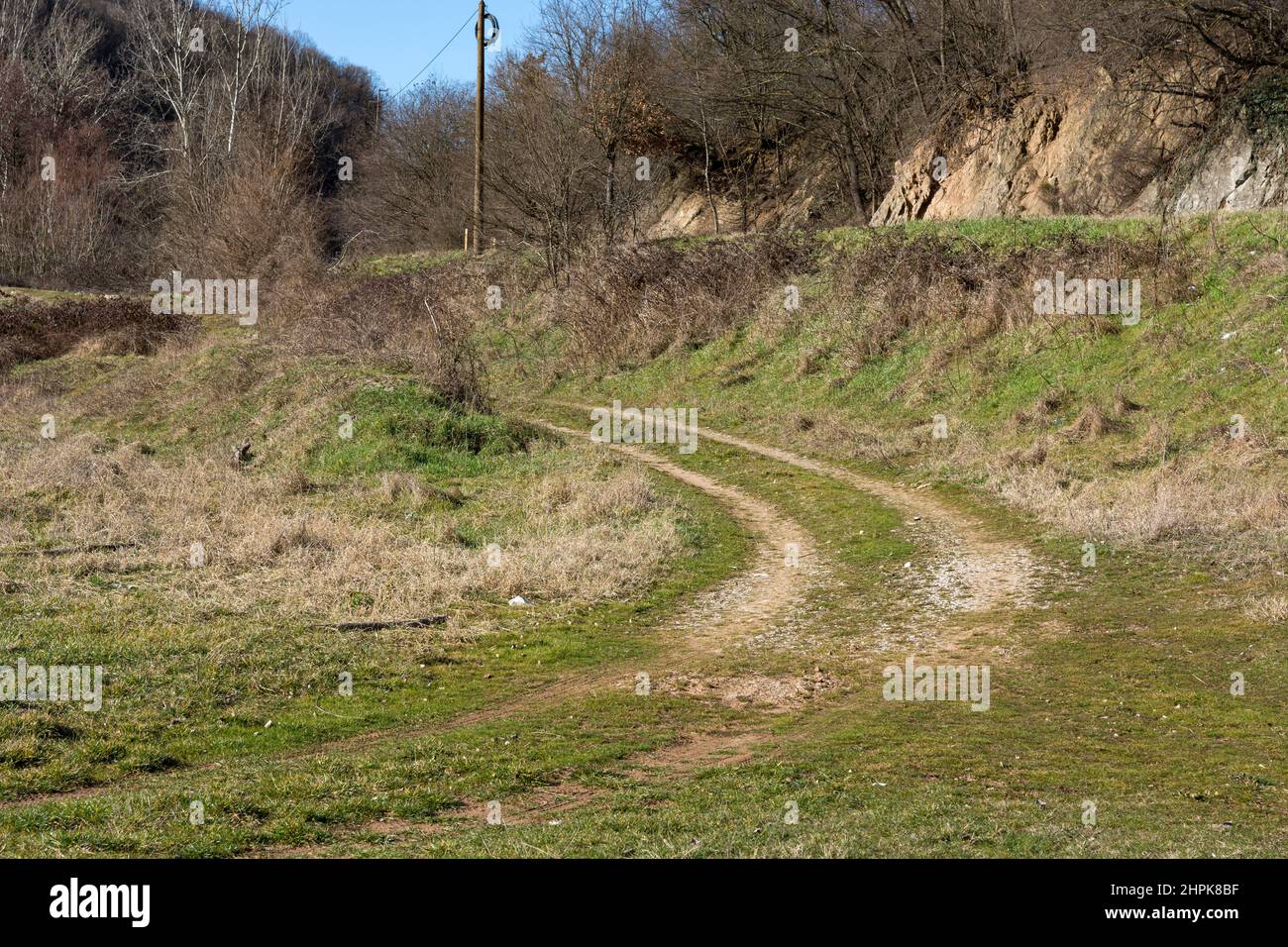 Rural unpaved road in the village on a sunny early spring day. Nature ...