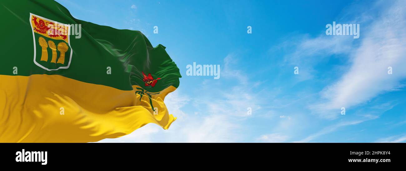 flag of Saskatchewan , Canada at cloudy sky background on sunset ...