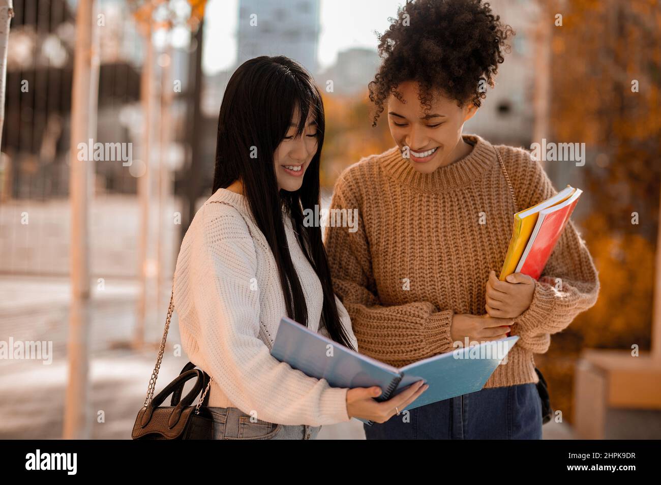 Female students discussing something before classes Stock Photo - Alamy