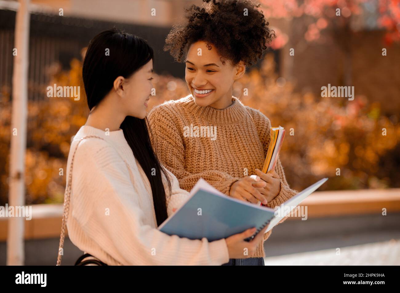 Female students discussing something before classes Stock Photo - Alamy