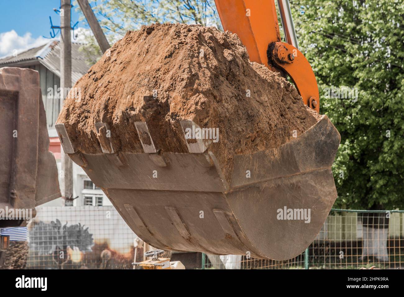 Excavation works. Tractor bucket digging the ground on a construction ...