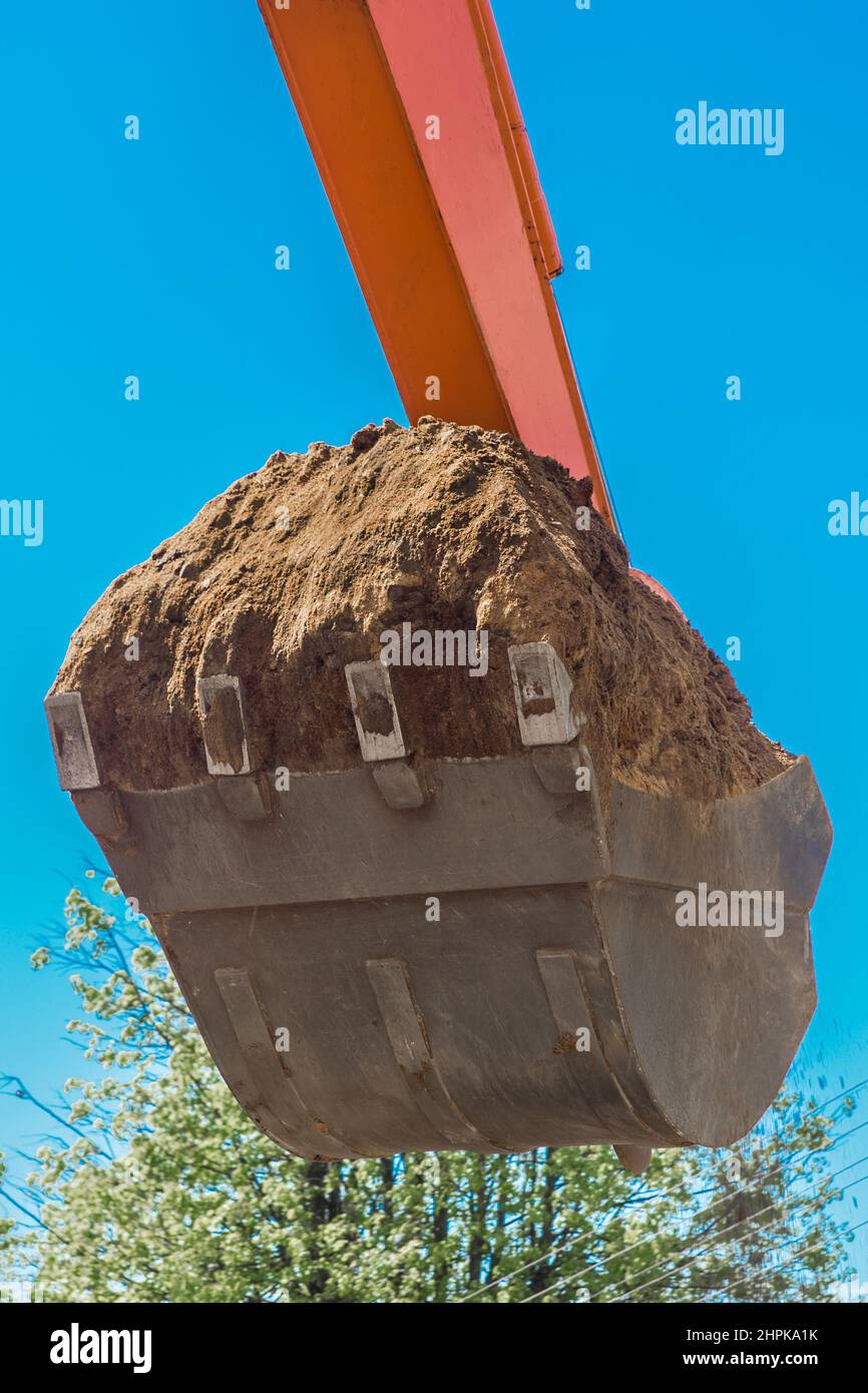 Excavation works. Tractor bucket digging the ground on a construction ...