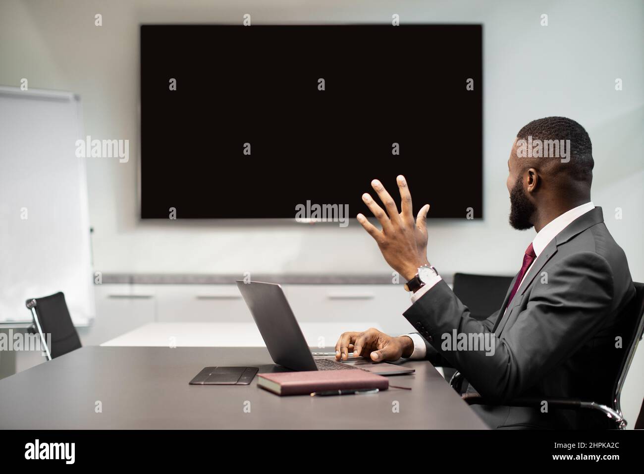African american manager sitting at desk, waving at blank screen Stock ...
