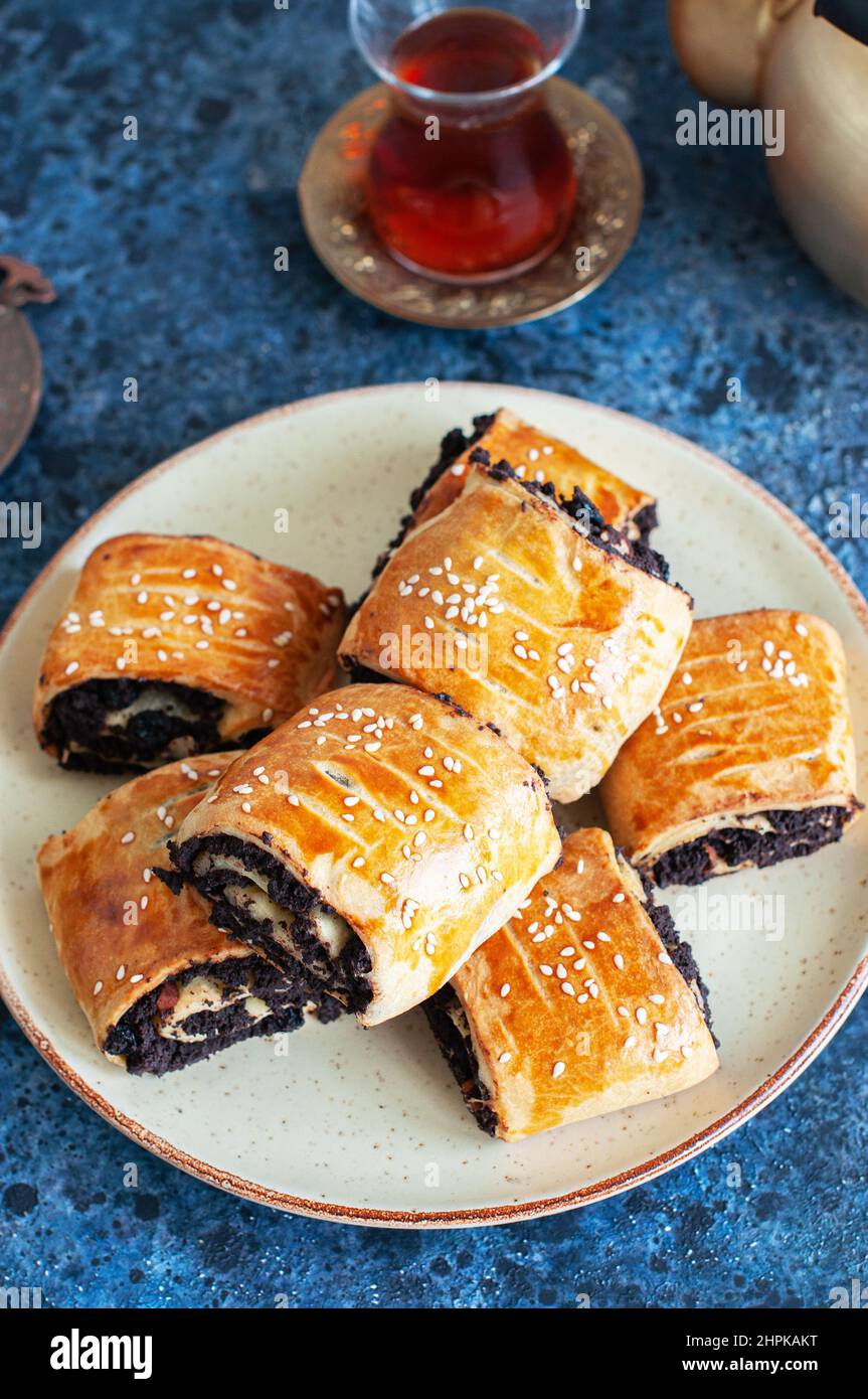 Traditional turkish pastry roll with chocolate and nuts filling on a ...