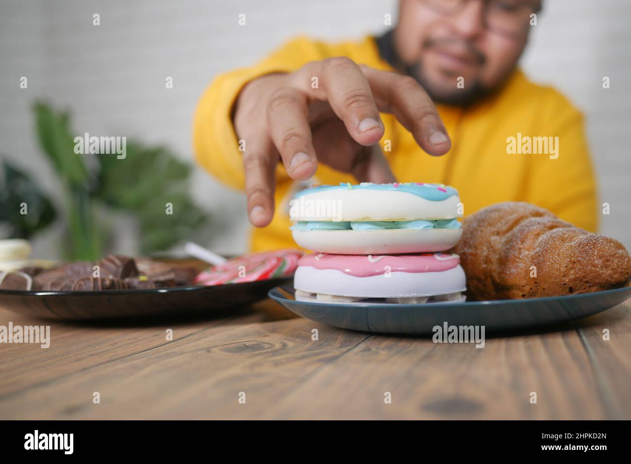 Young man eating donut hi-res stock photography and images - Alamy