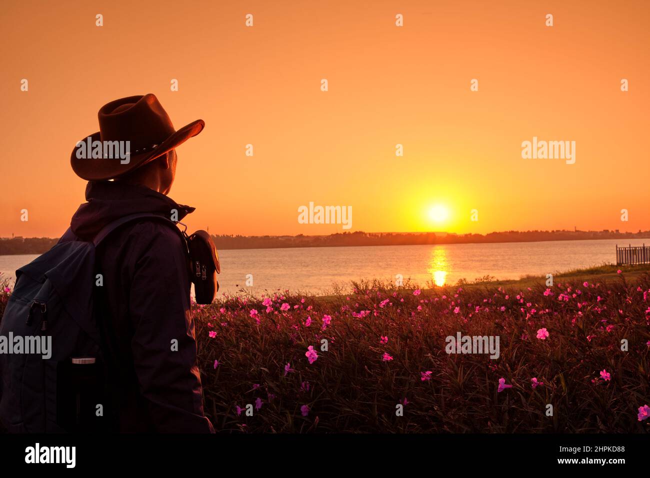 The lake sunset a male figure Stock Photo - Alamy