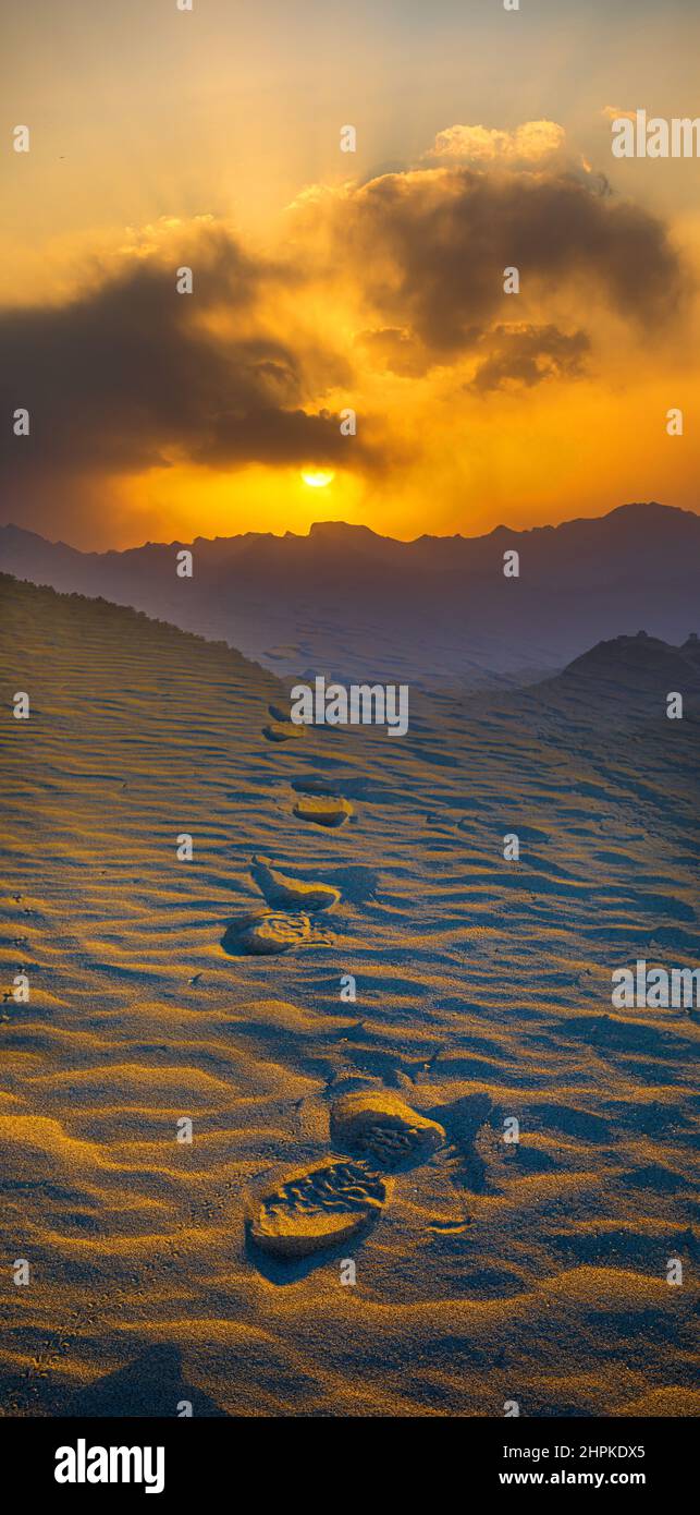 A line of big footprints on the sands of time Stock Photo - Alamy