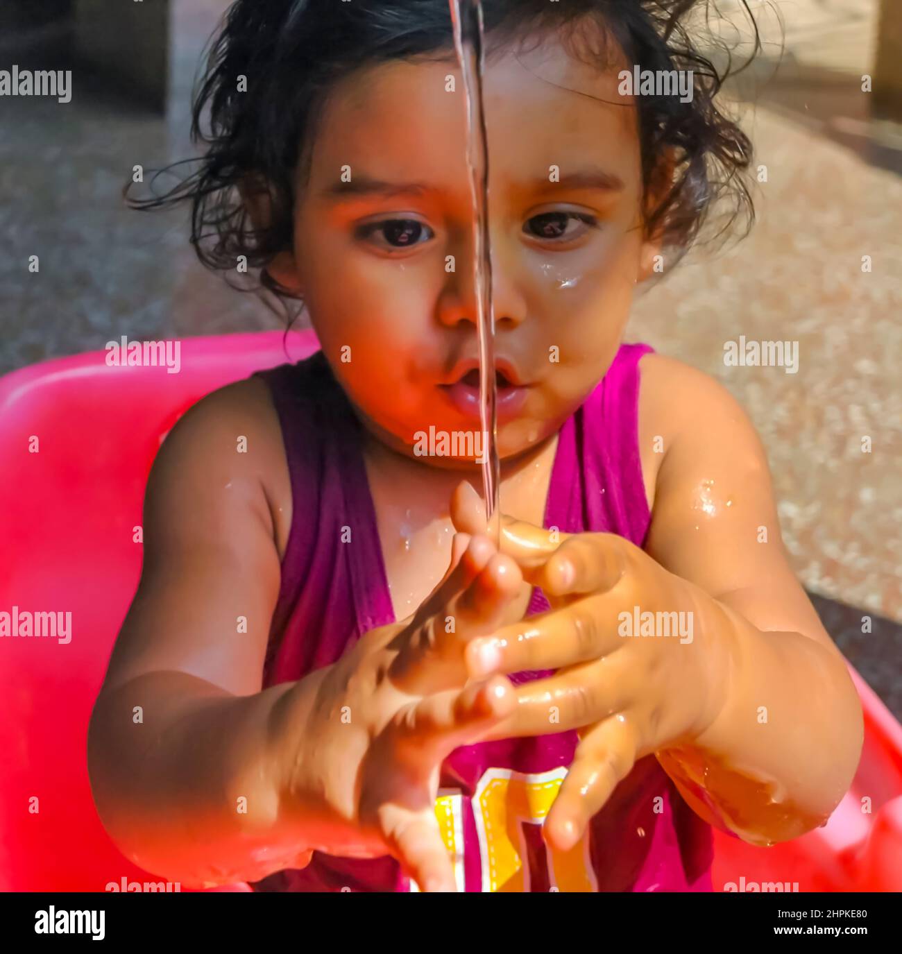An Indian / East Indian / Asian Indian baby boy / child / kid playing ...