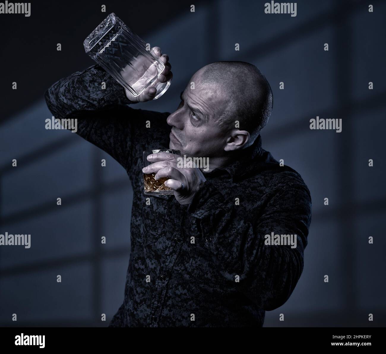Businessman checking his empty whiskey bottle after pouring the last ...