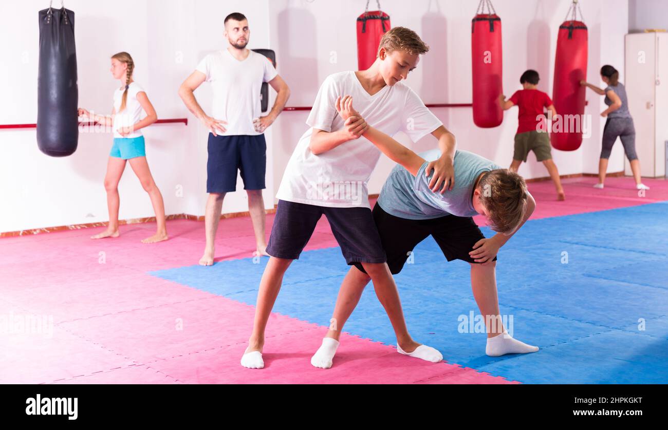 Kids practicing in pair self-protection Stock Photo - Alamy