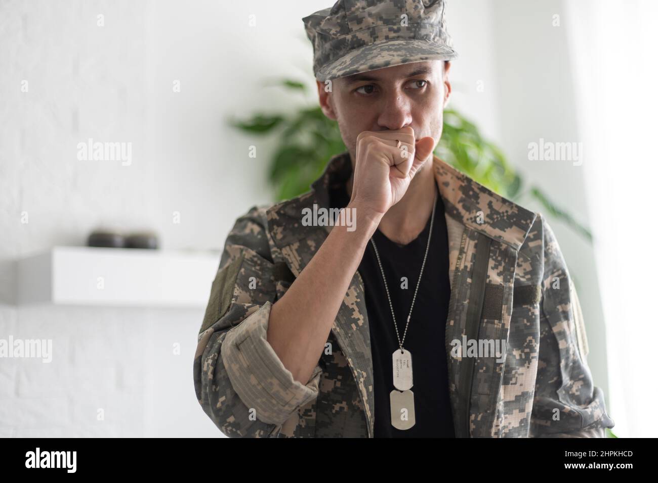 Soldier man isolated on white background is suffering with cough and ...